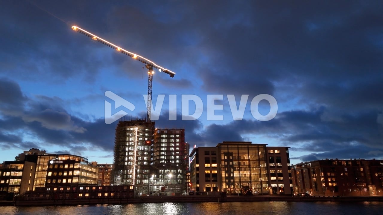 Illuminated crane and buildings at construction site on Malmo ...